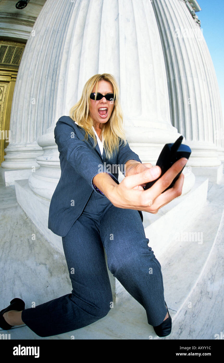 Businesswoman yelling into mobile phone Model Released Stock Photo - Alamy