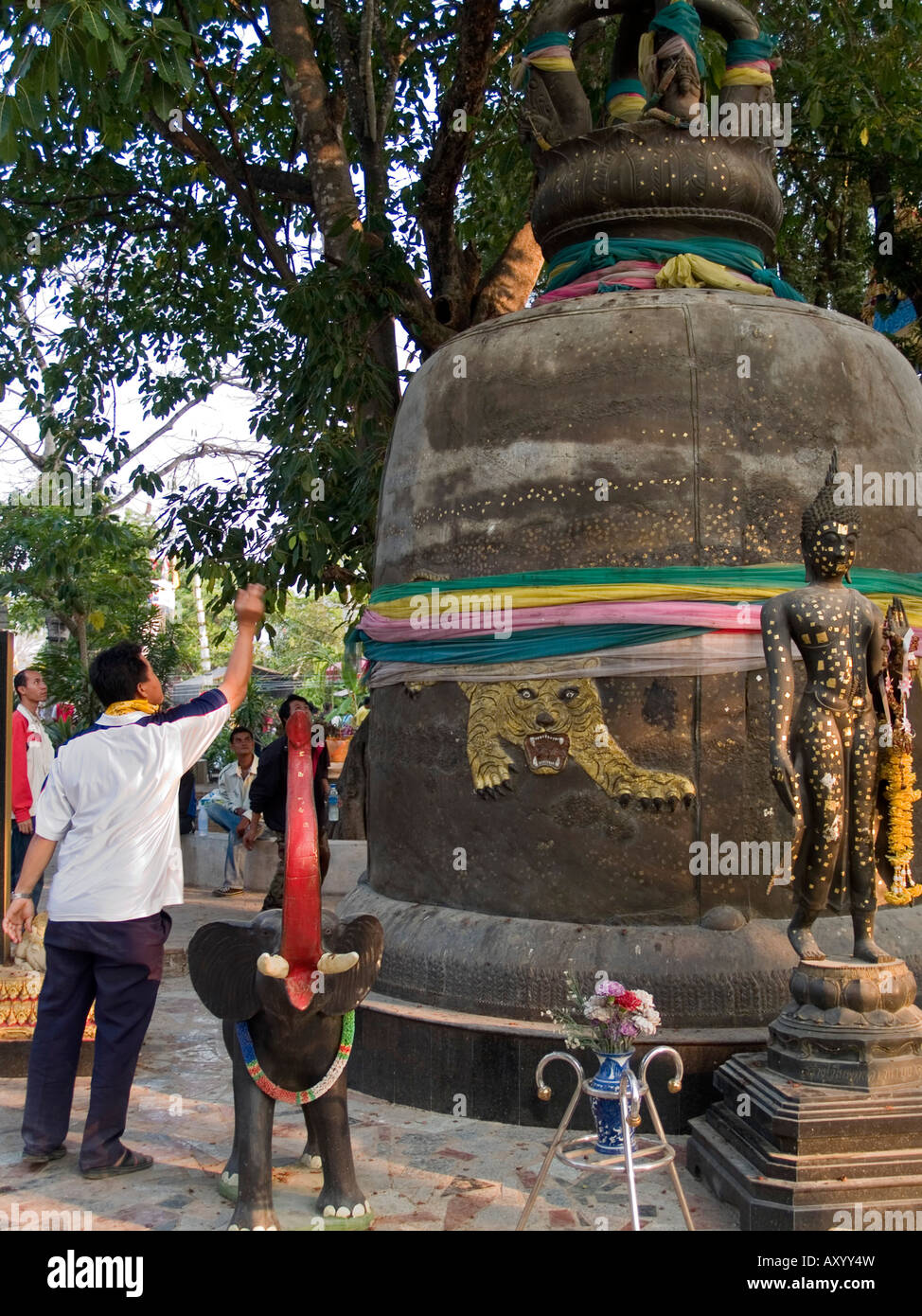 tossing coins for luck at the Wat Bang Phra Tattoo Festival in Thailand ...
