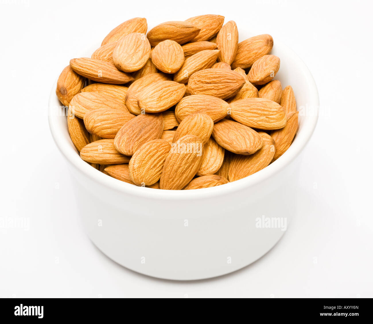 Almonds in a white bowl Stock Photo - Alamy