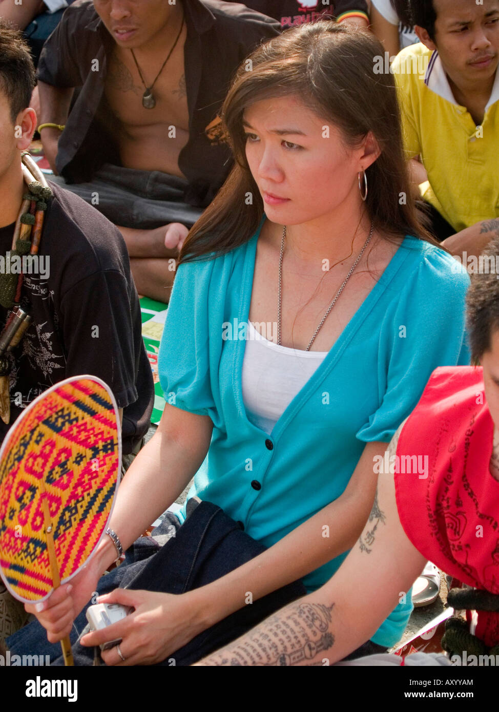 asian woman fanning herself at the Wat Bang Phra Tattoo Festival in ...