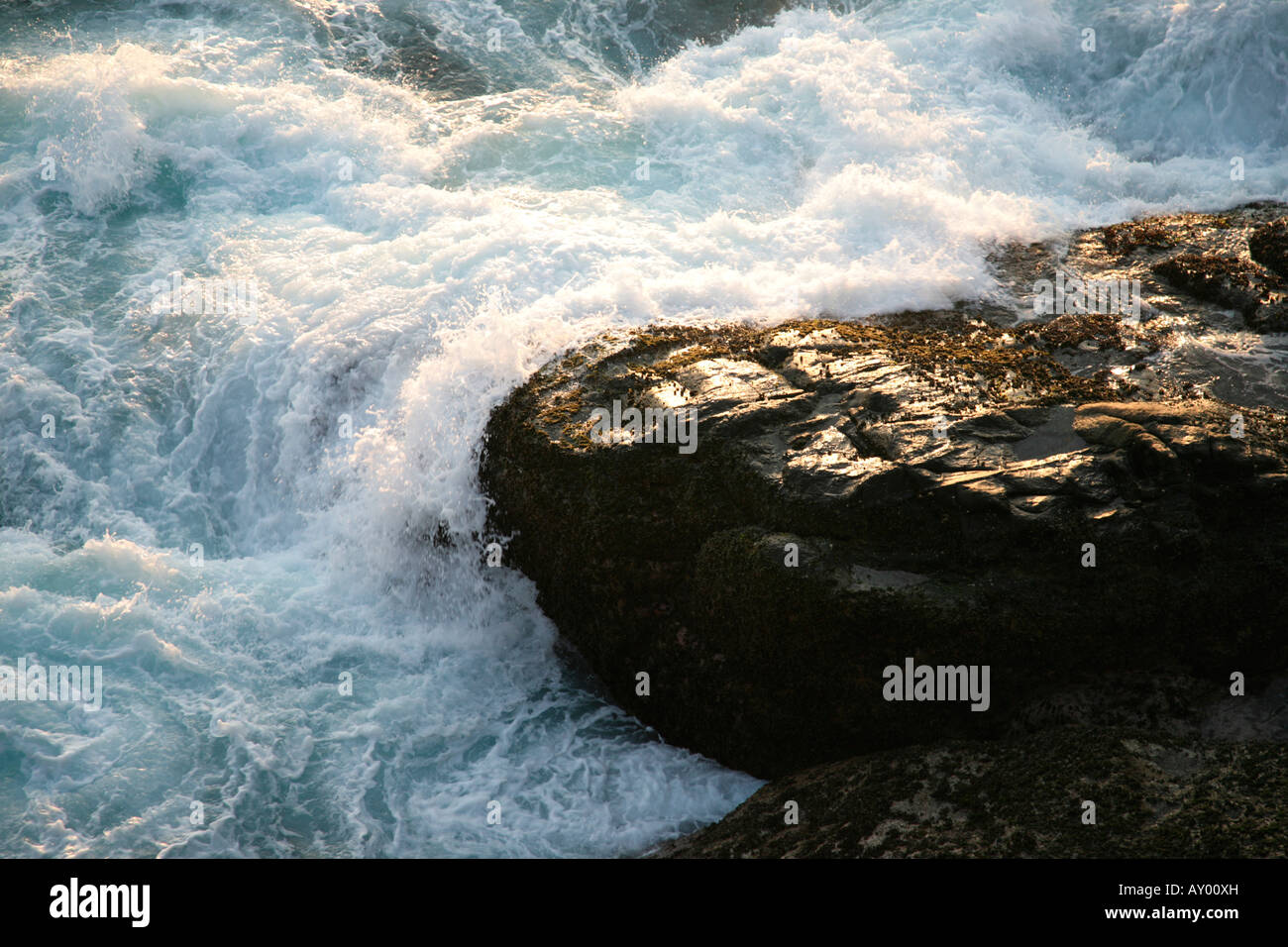 waves hitting rock at kovalam Stock Photo - Alamy