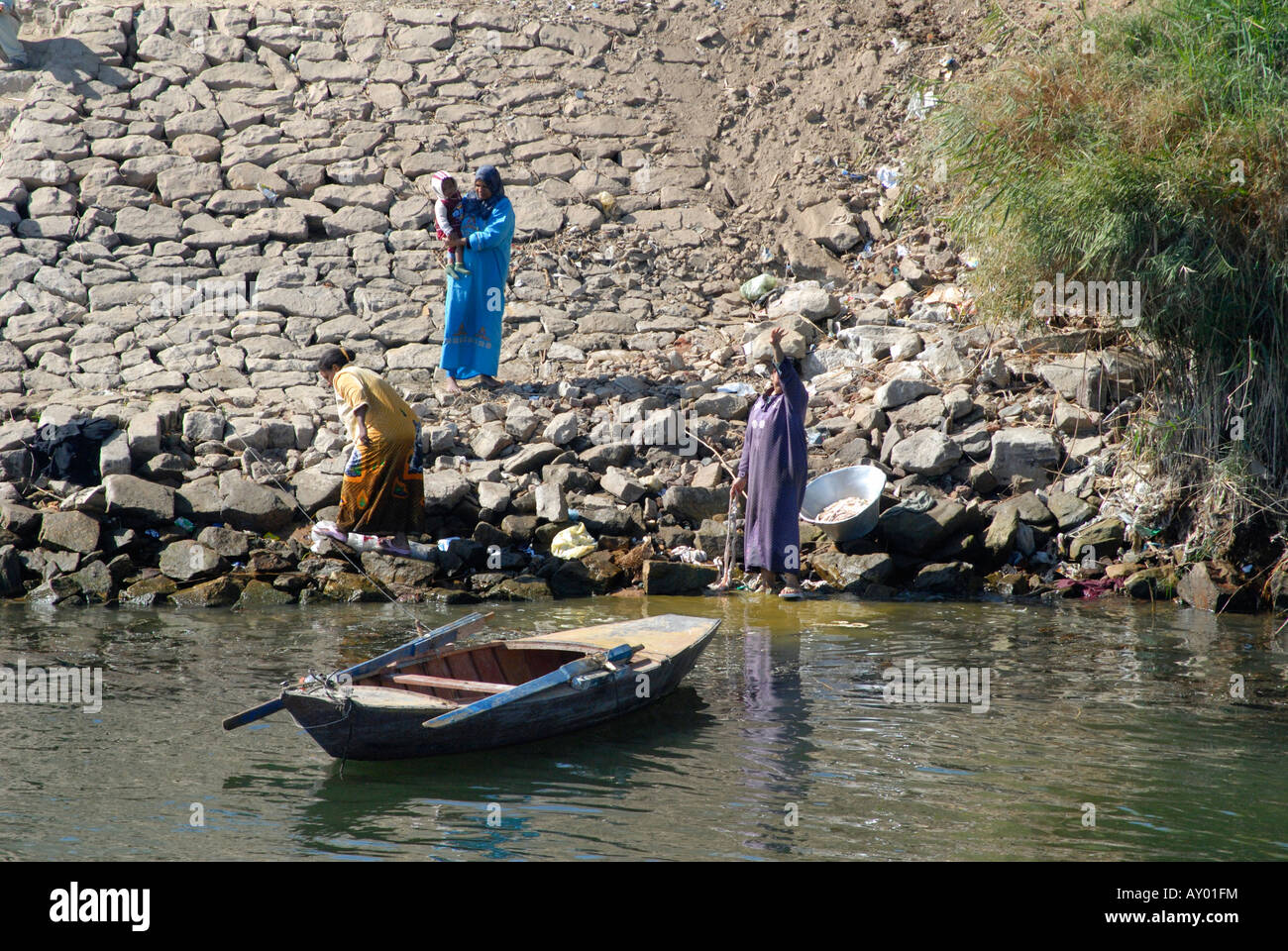 Cruising down the River Nile in Egypt with women washing clothes in th ...