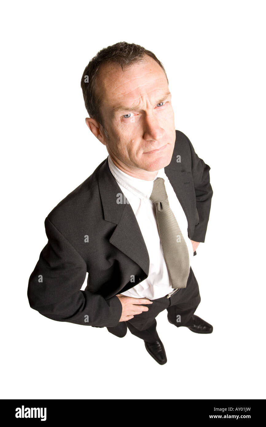 Business man standing in a black suit with a questioning suspicious ...