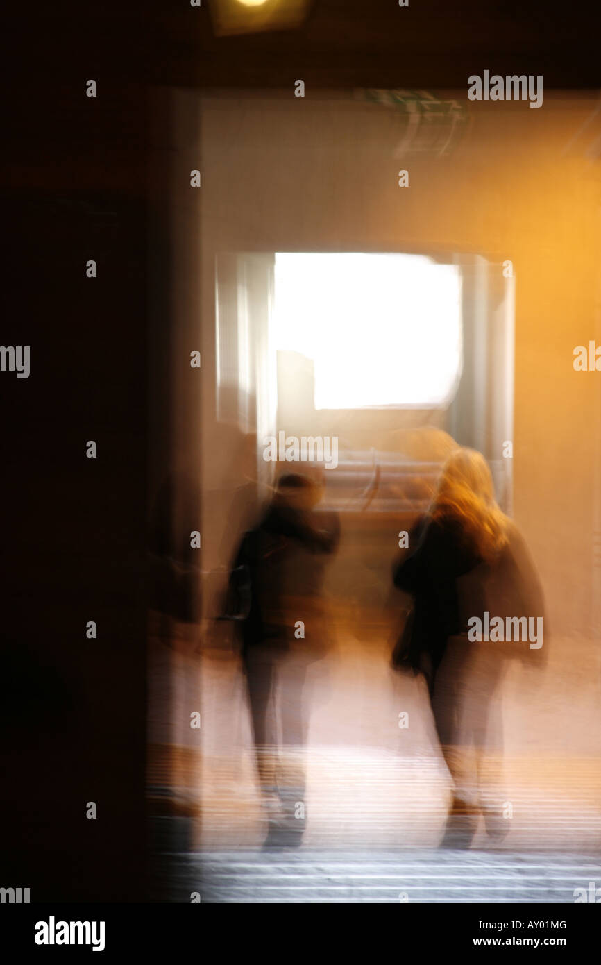 abstract two people walking in dark corridor at night Stock Photo - Alamy