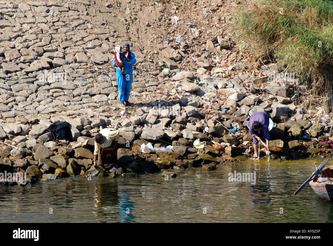 Cruising down the River Nile in Egypt with women washing clothes in th ...