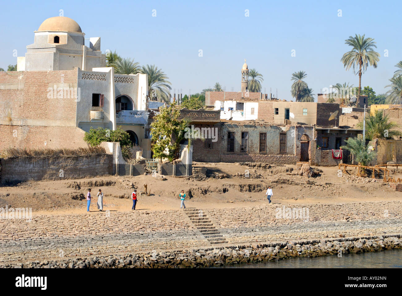 Cruising down the River Nile in Egypt with tradional town on riverbank ...