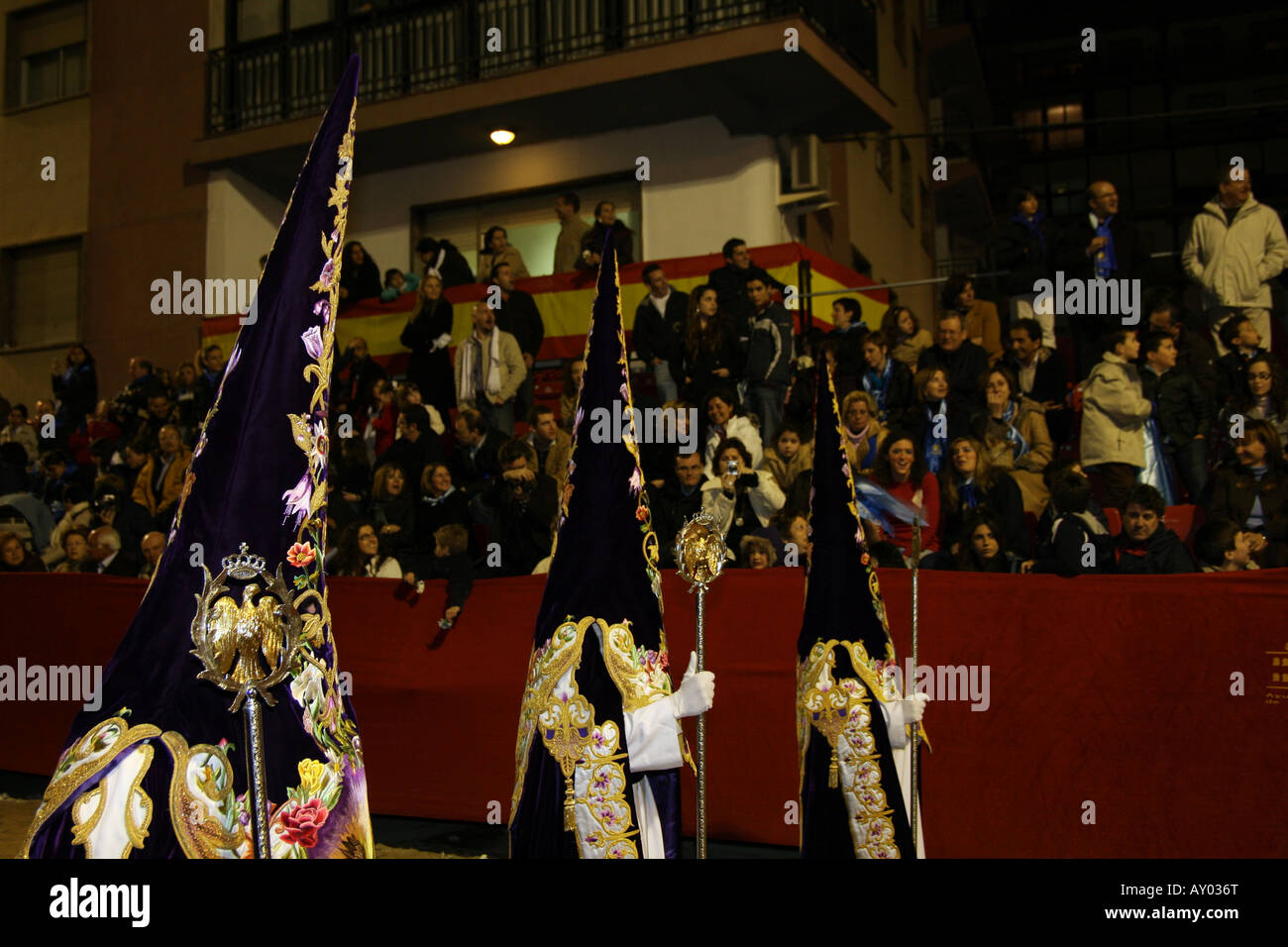 Three nazarenos wearing robes embroidered in gold and silk thread, Paso ...