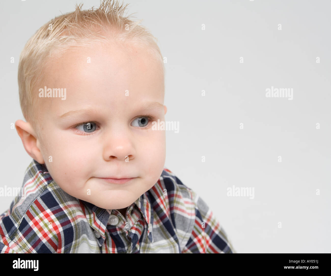small boy with a wry smile Stock Photo - Alamy