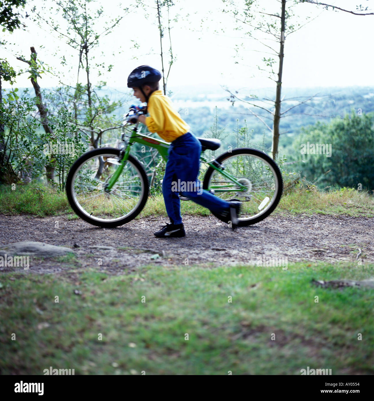 Pushing bike up a slope Stock Photo - Alamy