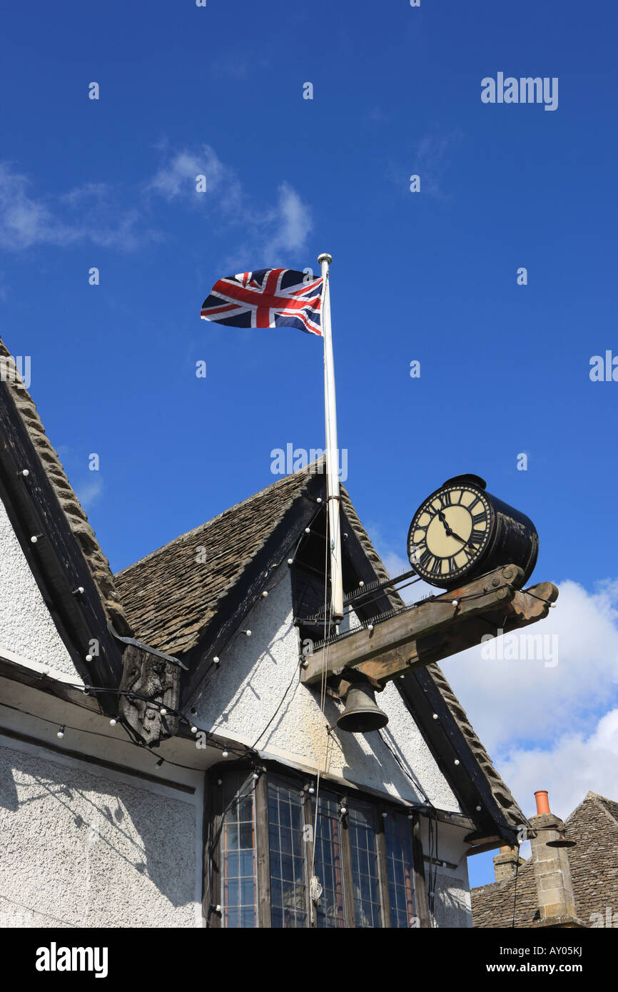 Flag clock over market house with its large clock, in the High Street ...