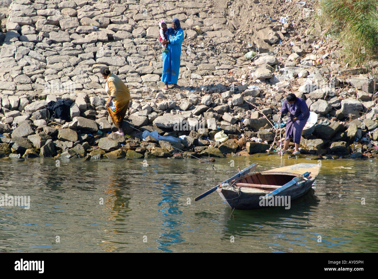 Cruising down the River Nile in Egypt with women washing clothes in th ...
