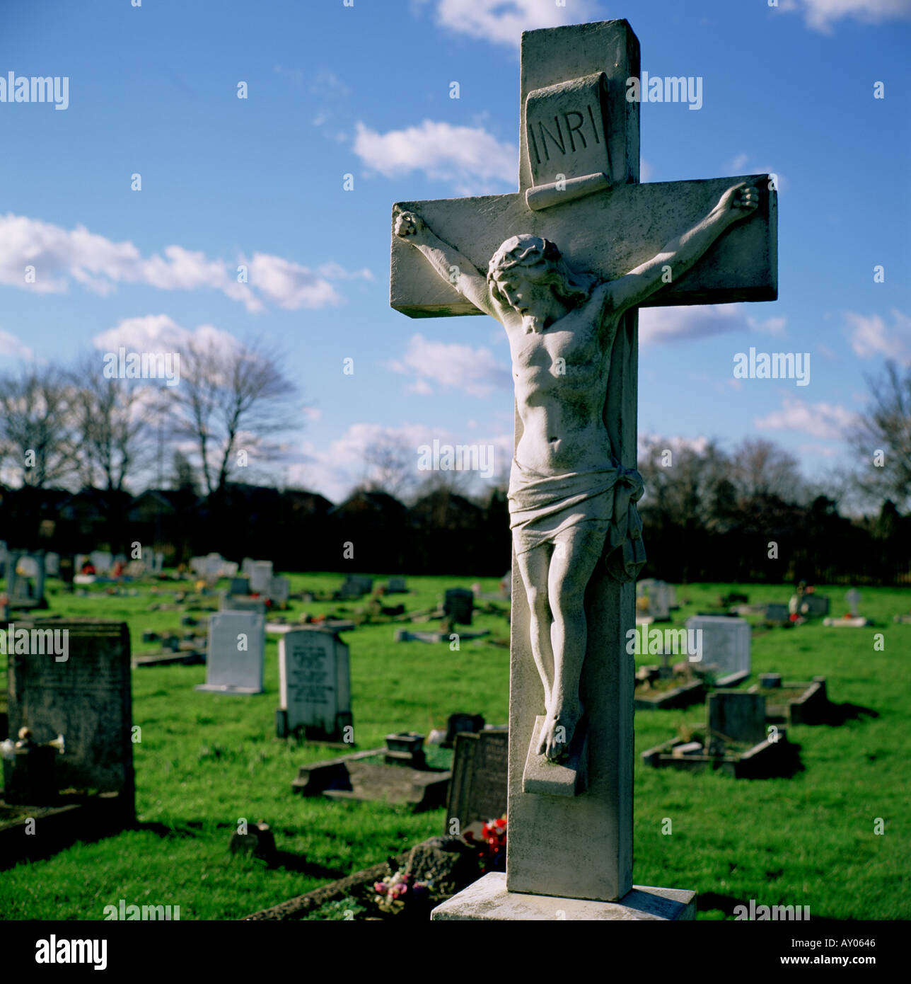 a headstone in a graveyard depicting jesus christ on a cross during the crucifixion Stock Photo ...