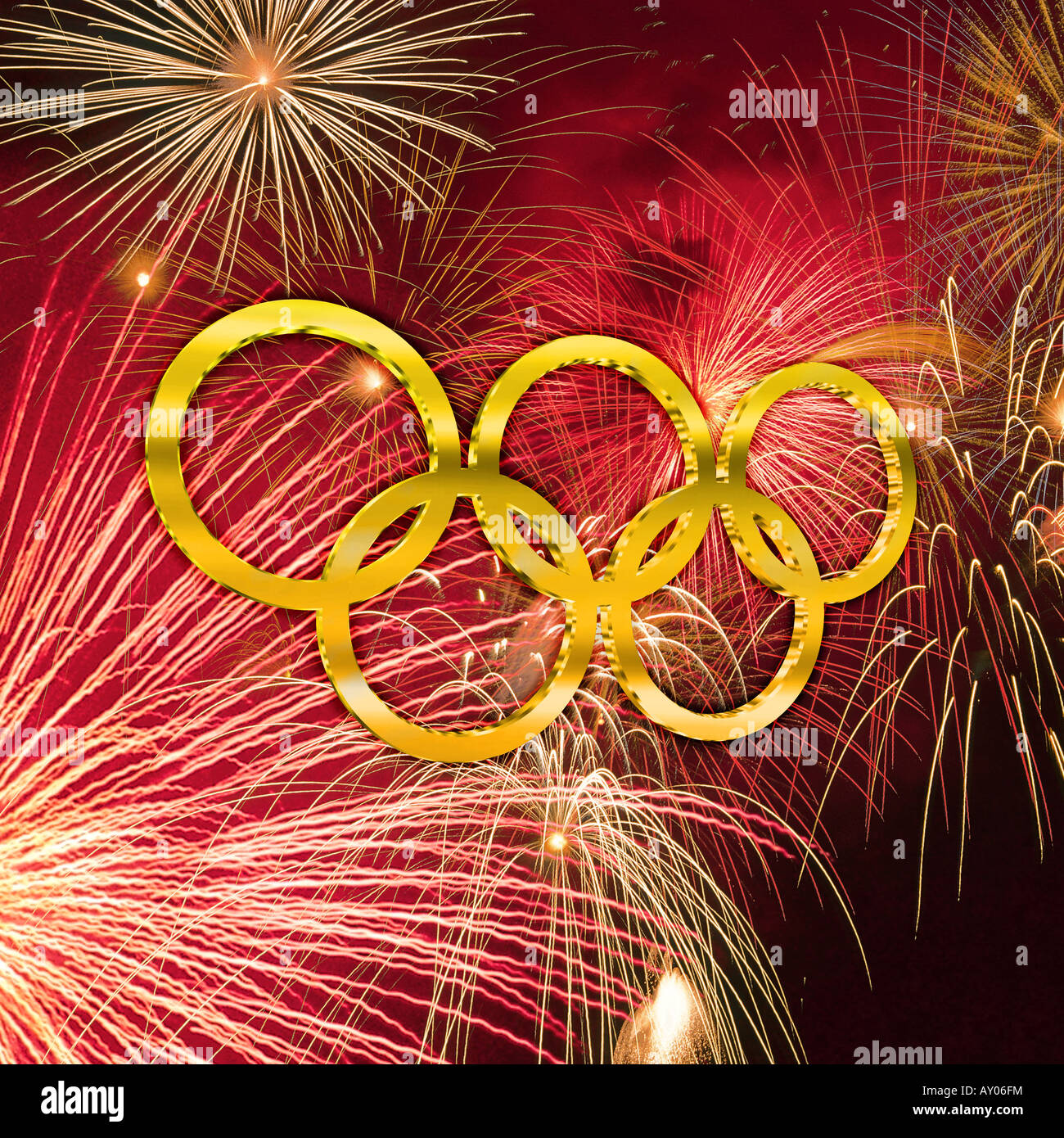 Bright golden olympic rings against a sky filled with sparkling bursts ...