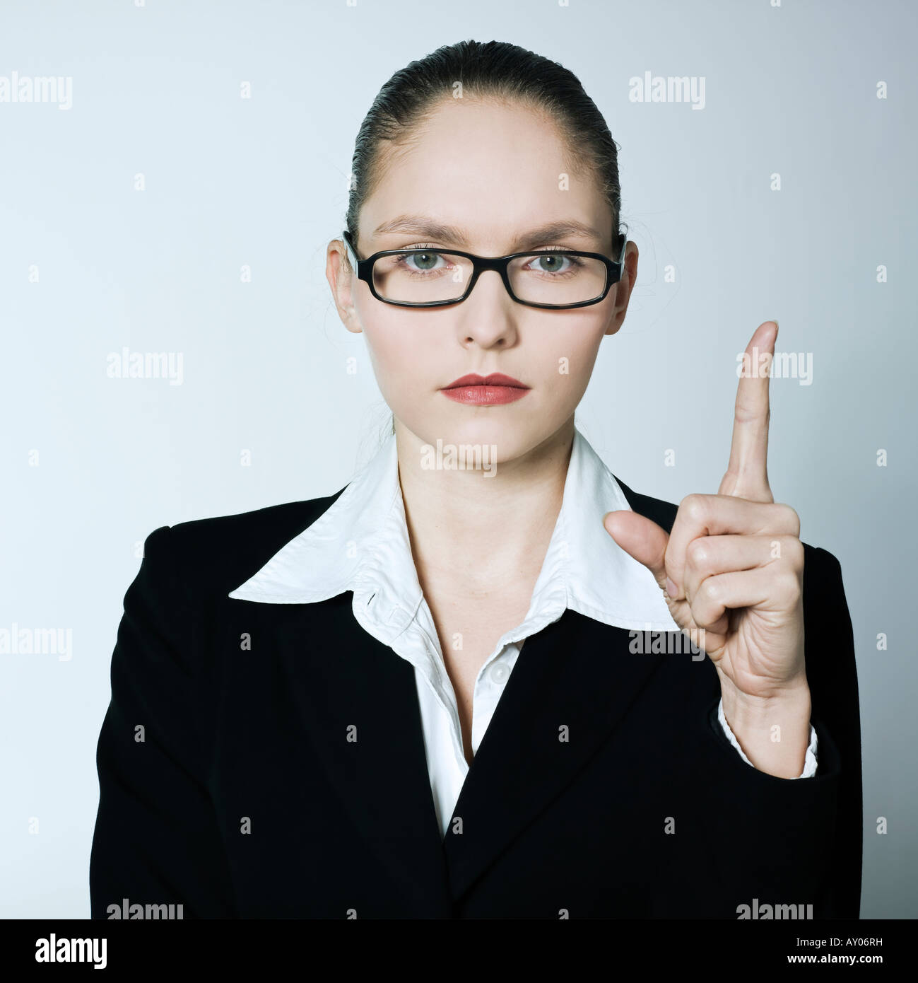 studio shot portrait of a beautiful young and strict woman in a costume ...