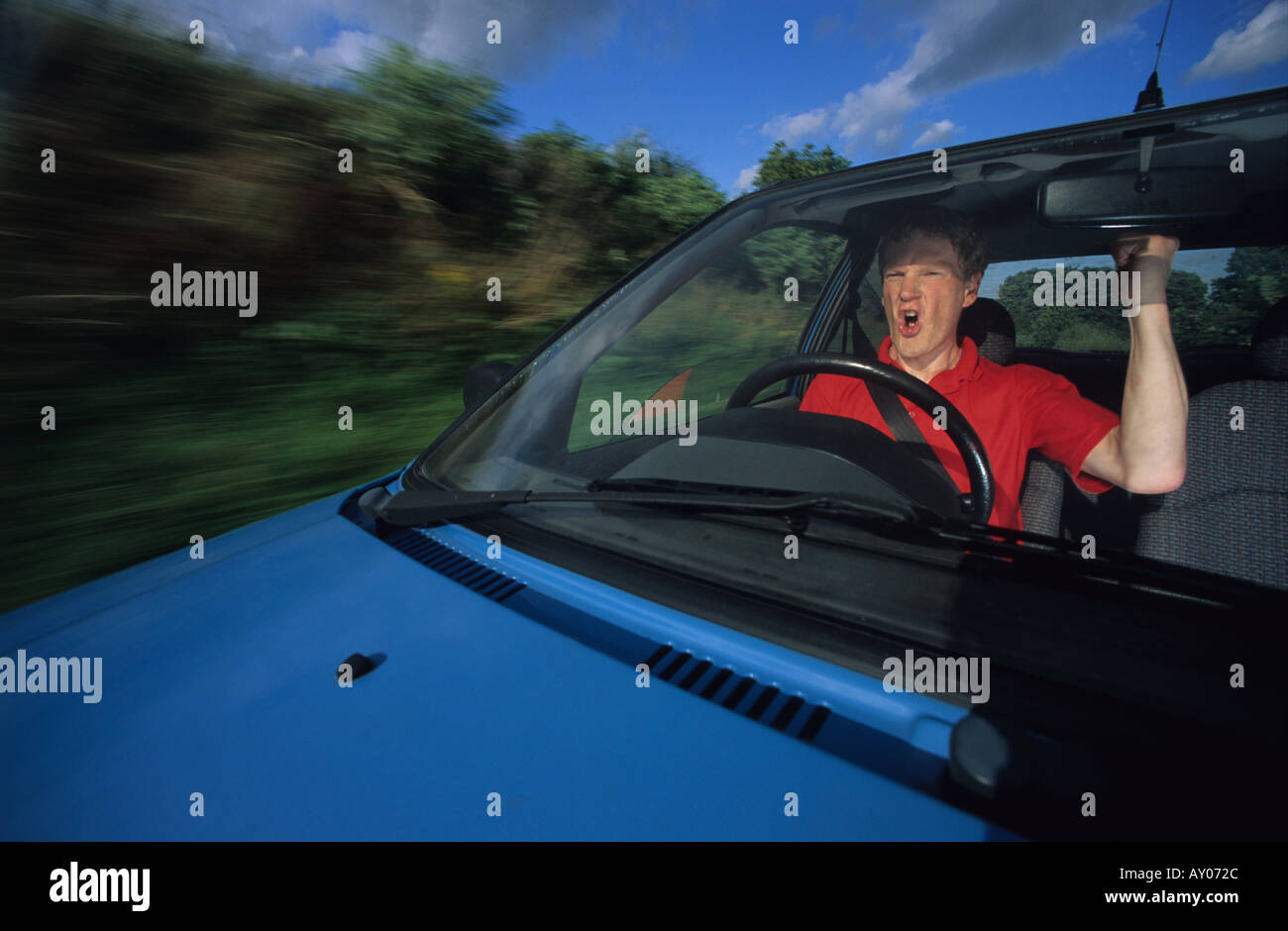 irate driver showing signs of road rage waving fist at other drivers uk ...