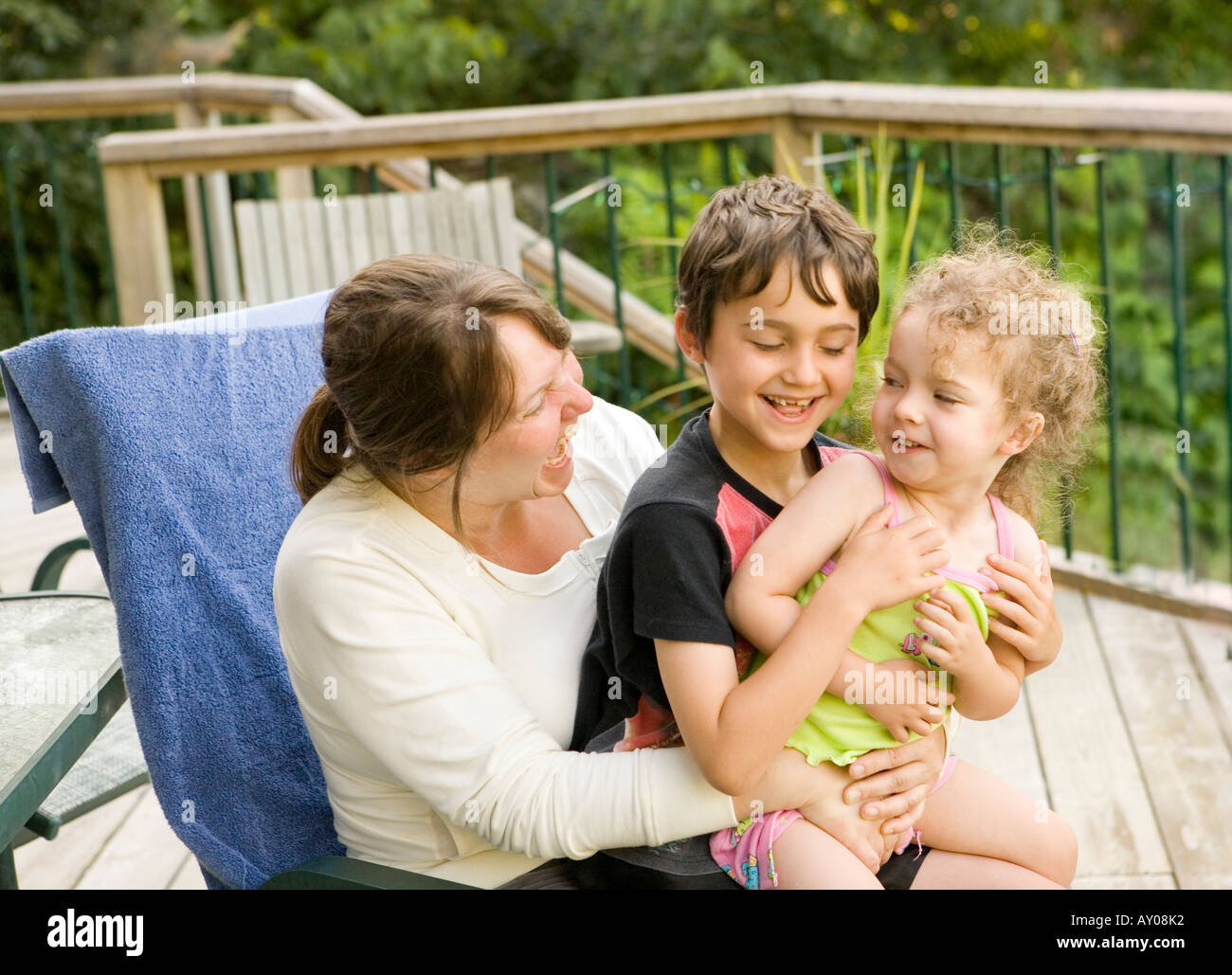 Mother with her two kids laughing Stock Photo - Alamy