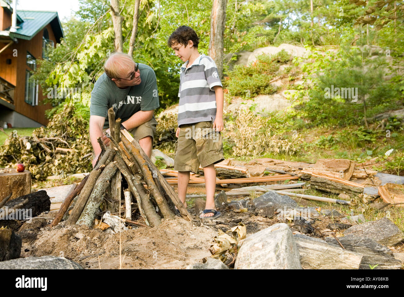 Father teaches his son how to build a bonfire Stock Photo - Alamy