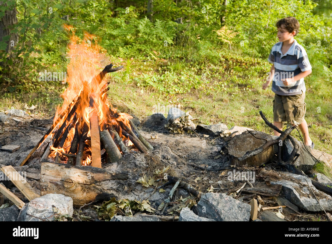Boy looking at a bonfire Stock Photo - Alamy