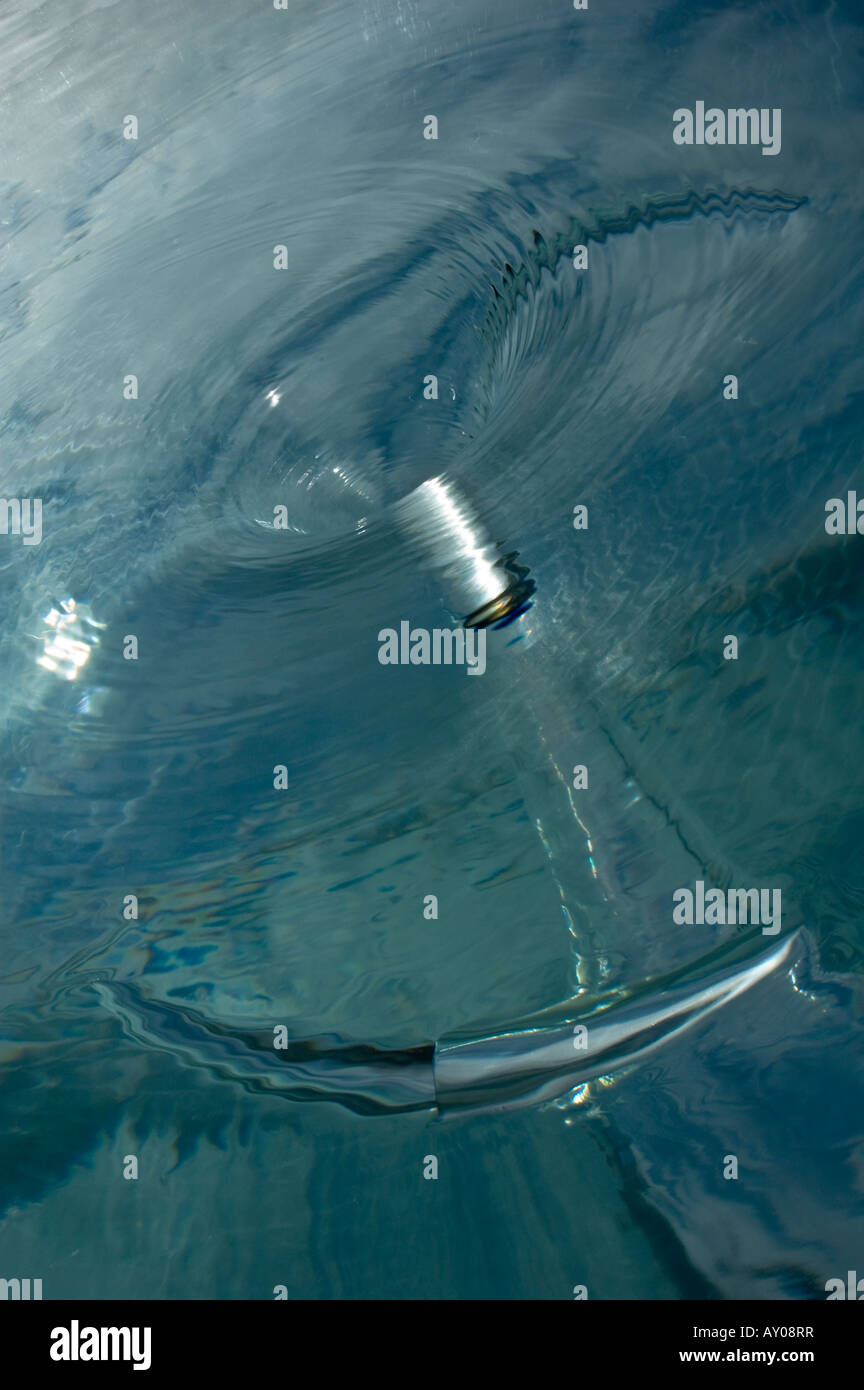 Swirling blue water (whirlpool vortex) in a garden water feature Stock ...