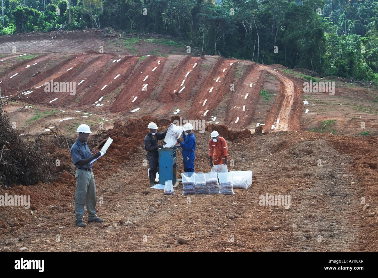 Grade control geologist with GC samplers packing samples before ...