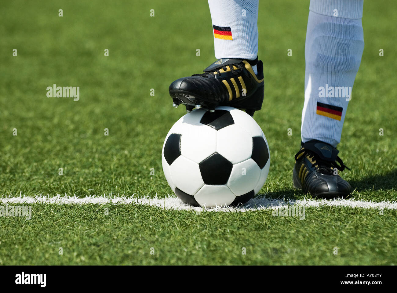 the feet of a german national football player and a vintage black and ...