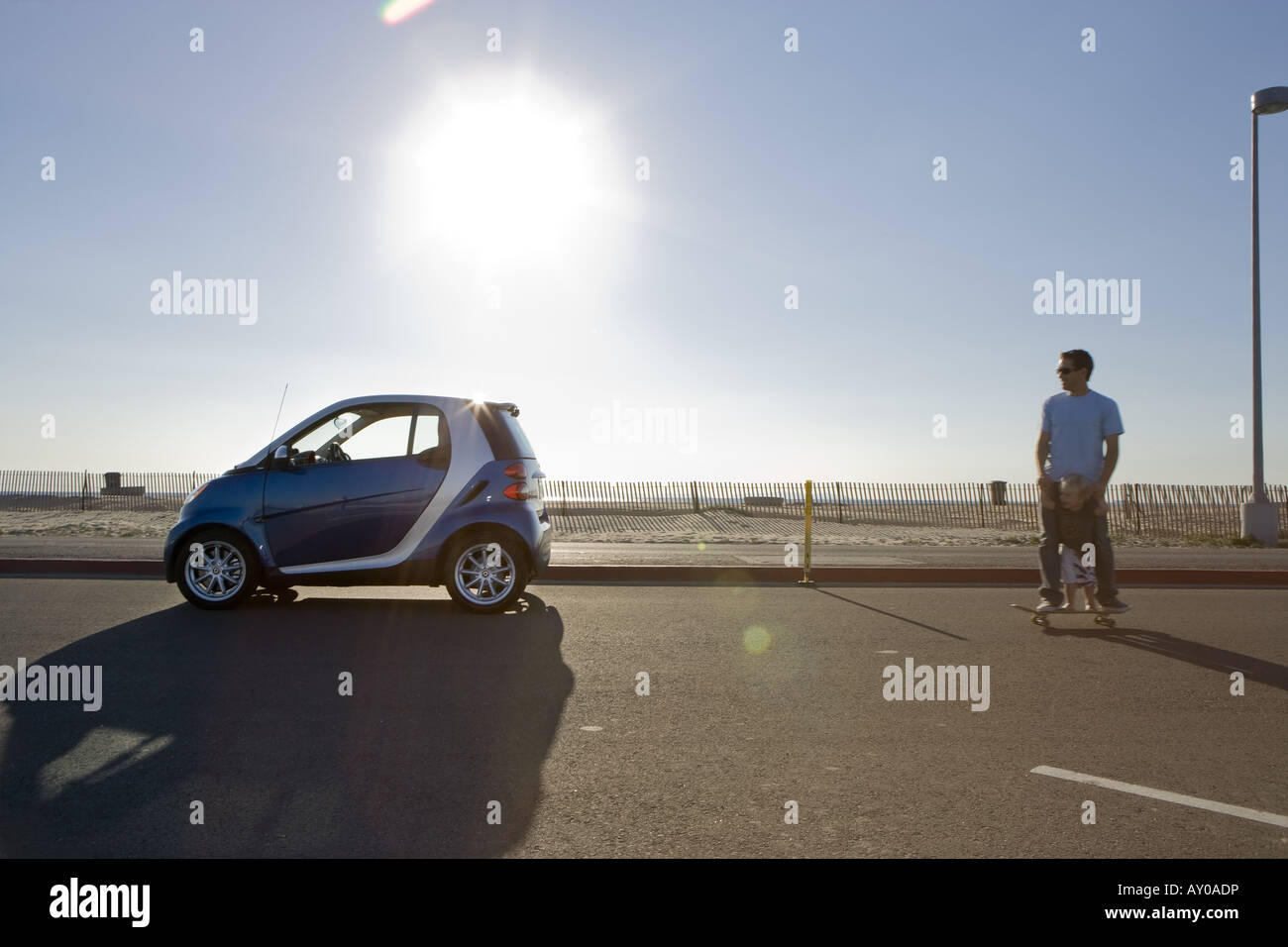 Man and son at beach with Smartcar compact car Stock Photo - Alamy