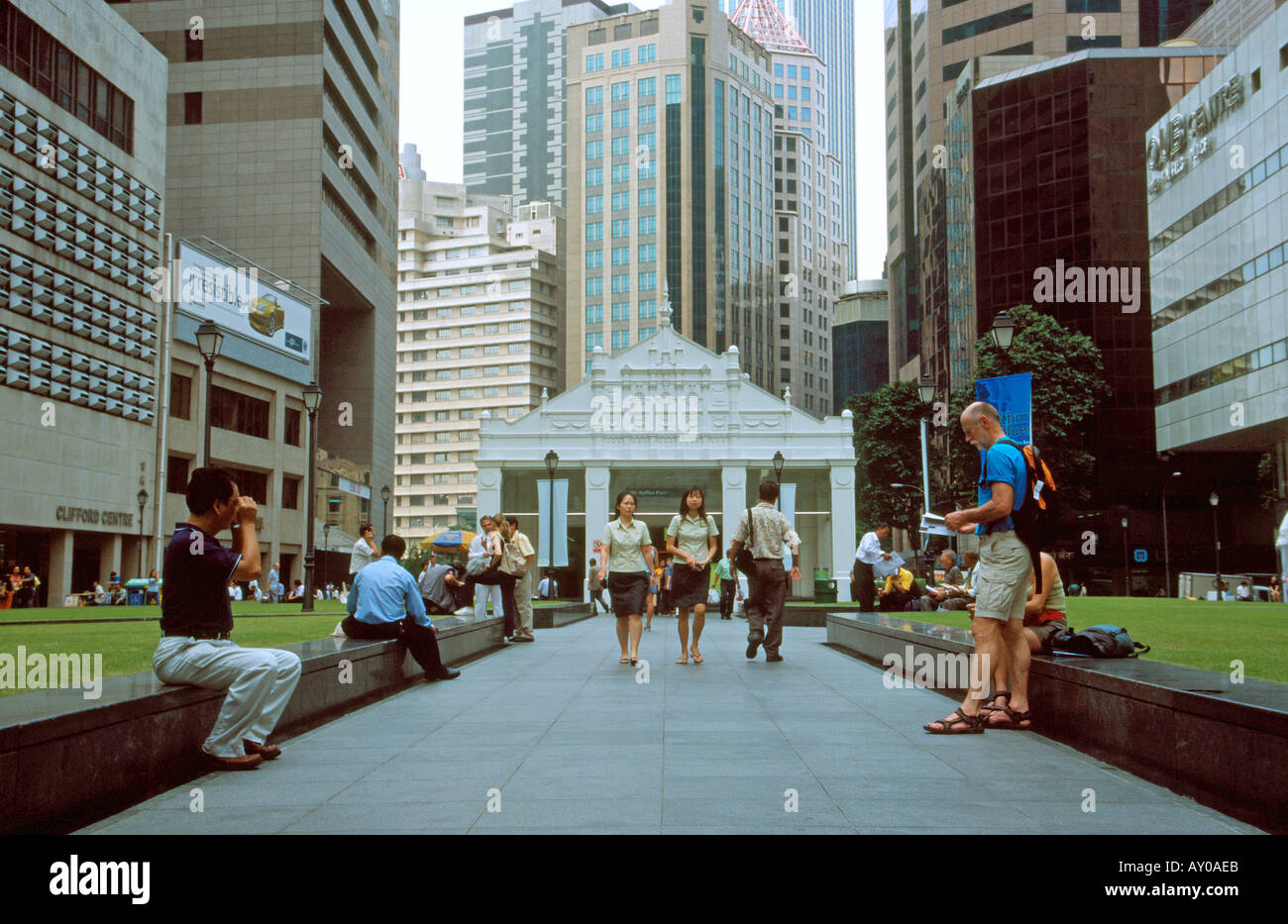 Business people and tourists gather at Raffles Place heart of the CBD ...