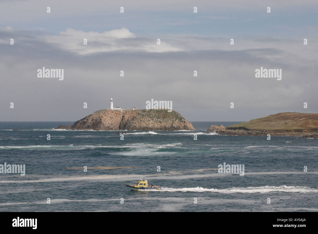 A small ferry boat traverses the rough water between St Martin s and ...