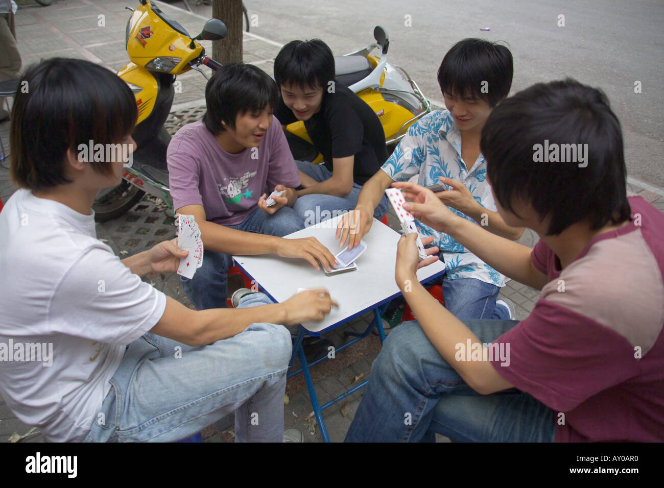 Chinese street kids playing cards Stock Photo - Alamy