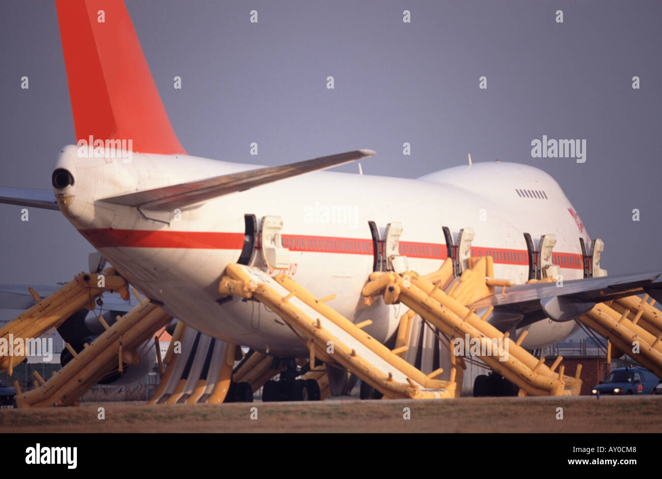 Dramatic shot of Jumbo Jet Boeing 747 with all its escape chutes down ...