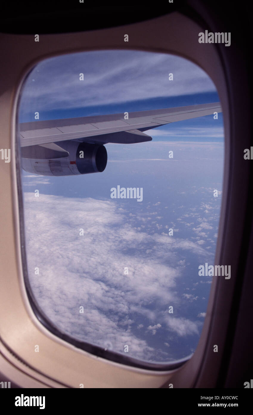 view looking out of an airplane window showing plane and wing and ...