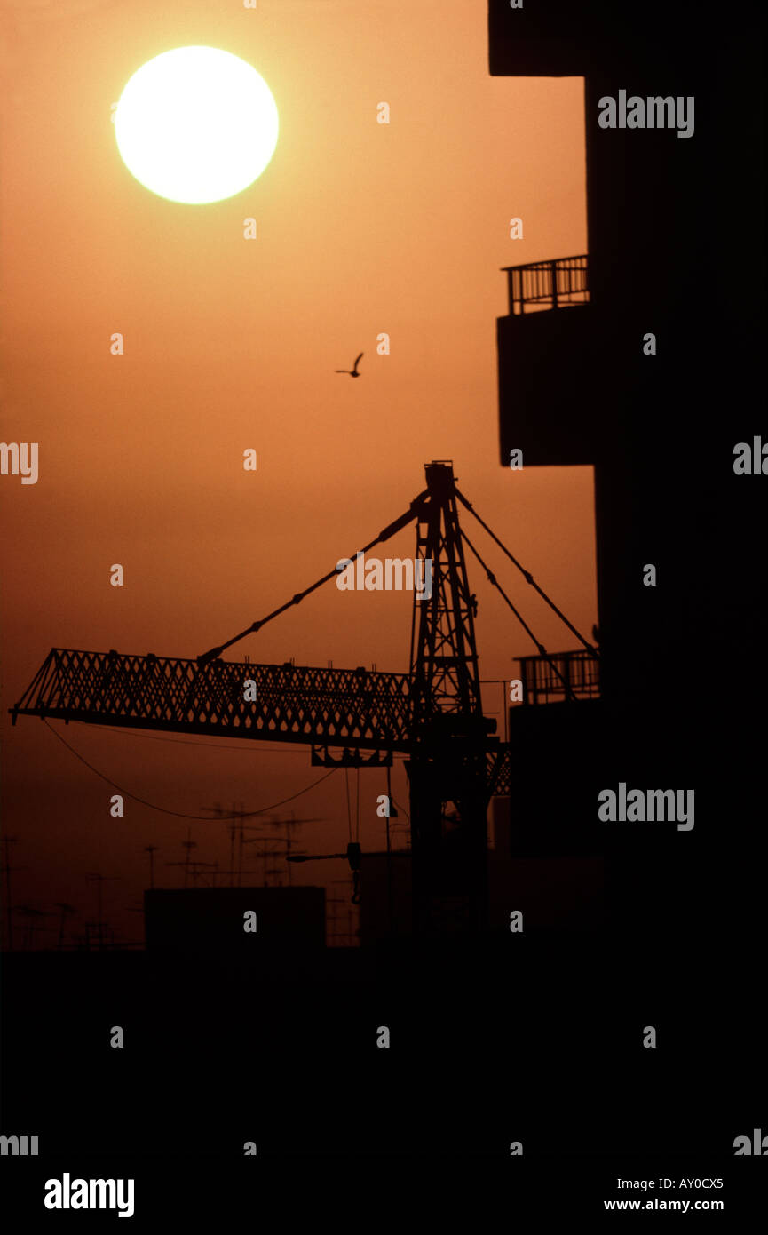 saudi sunset seen through a building site crane on the jeddah corniche ...