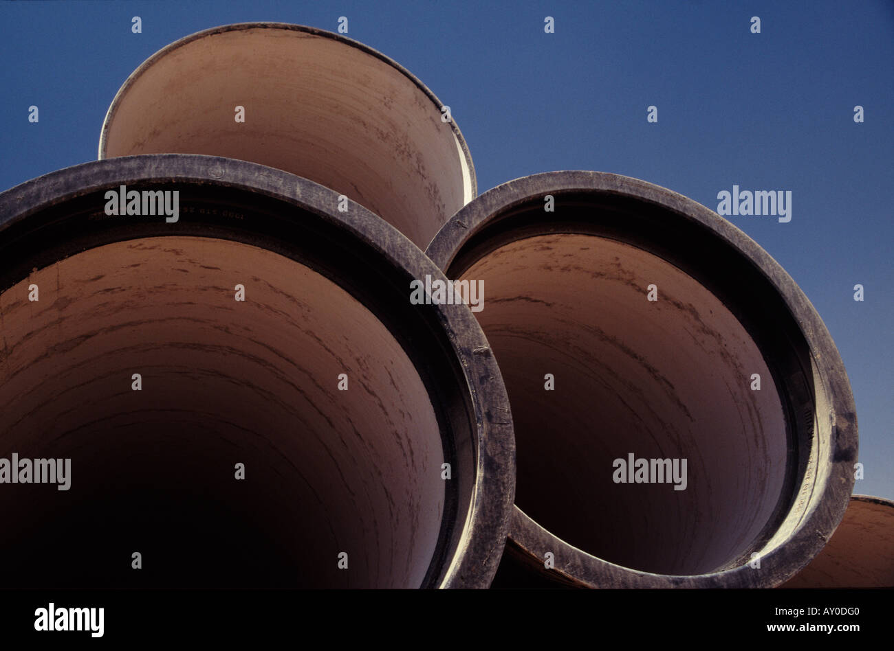 graphic detail and closeup of industrial pipes shot against a deep blue ...