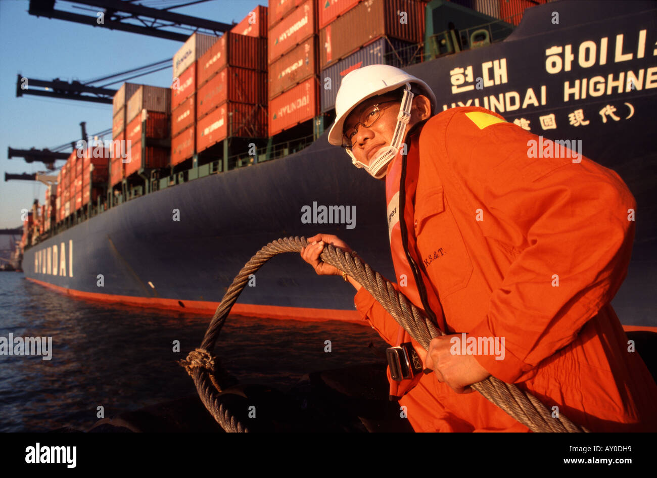 Hong Kong sailor at kwai chung container port on board tugboat feeding ...