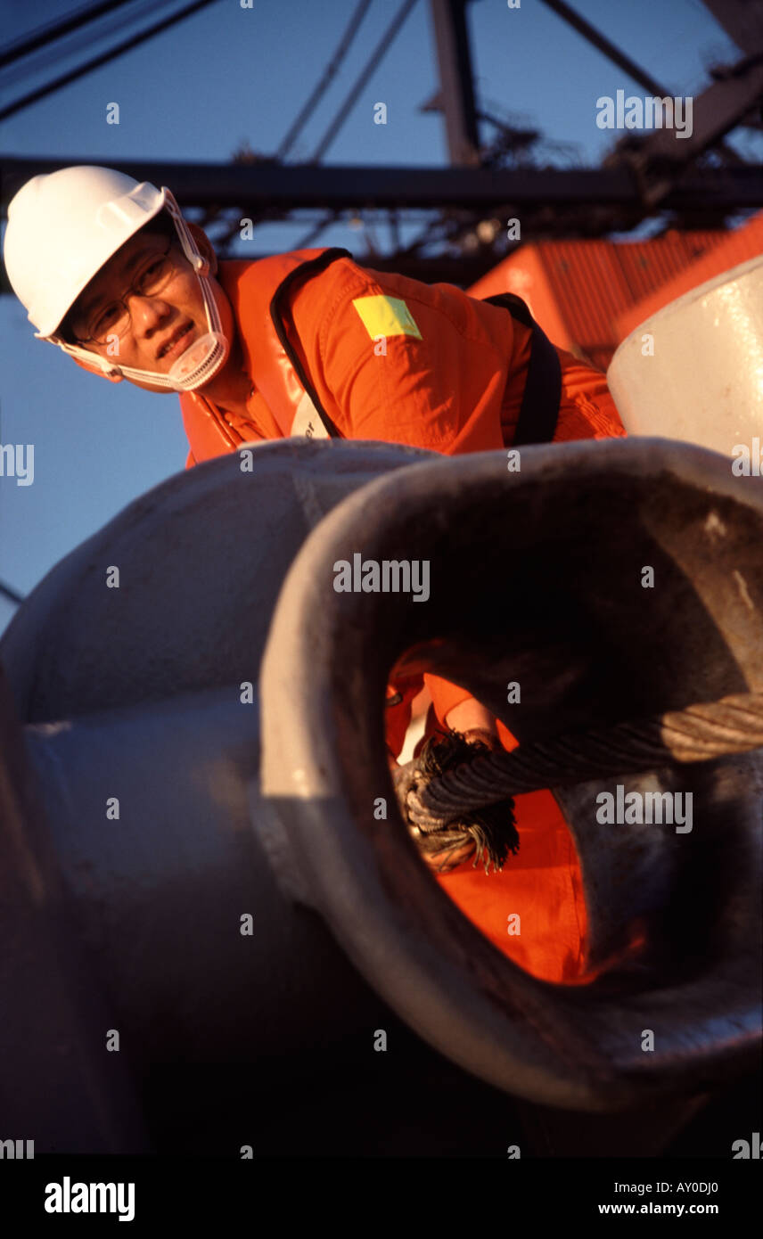 Hong Kong sailor at kwai chung container port on board tugboat feeding ...