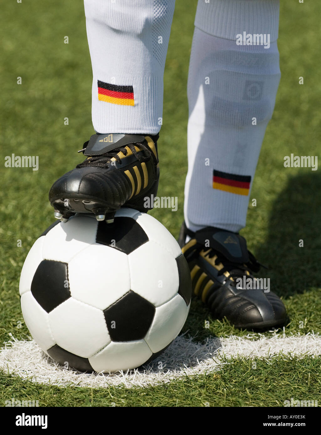 the feet of a german national football player and a vintage black and ...