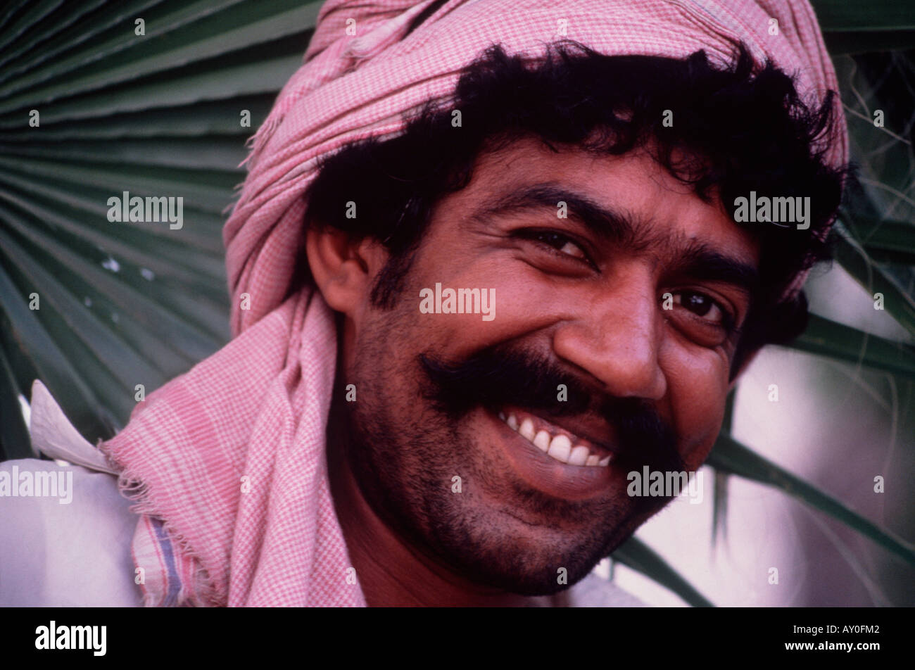 smiling arabic man with toothy grin looking at camera with a happy face ...