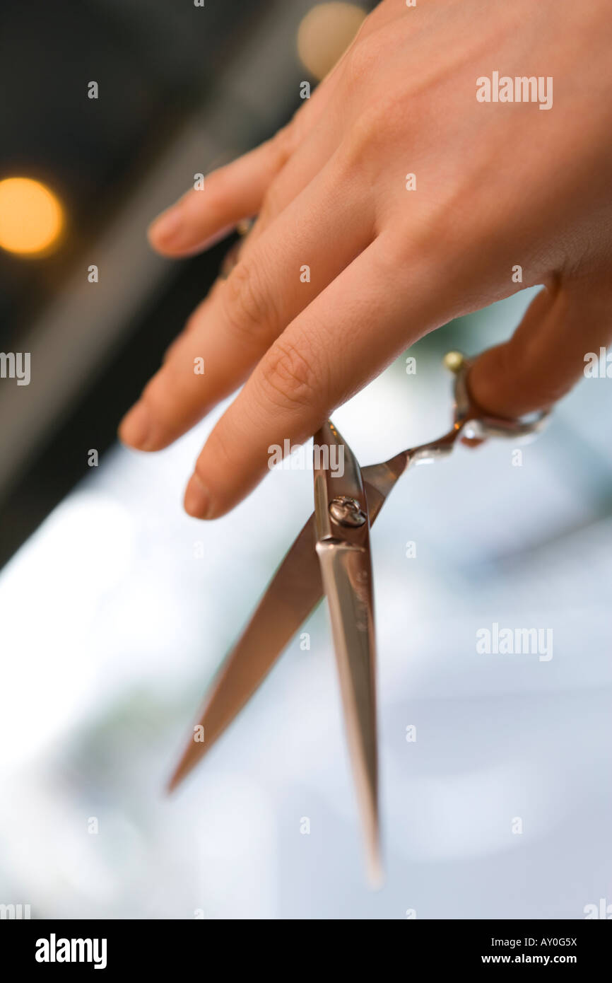 Hairdresser with scissors in hand Stock Photo - Alamy