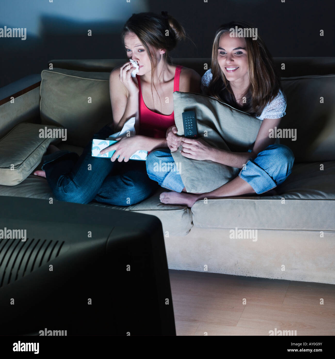 pictures in a living room of two young girls crying sitting on a couch ...