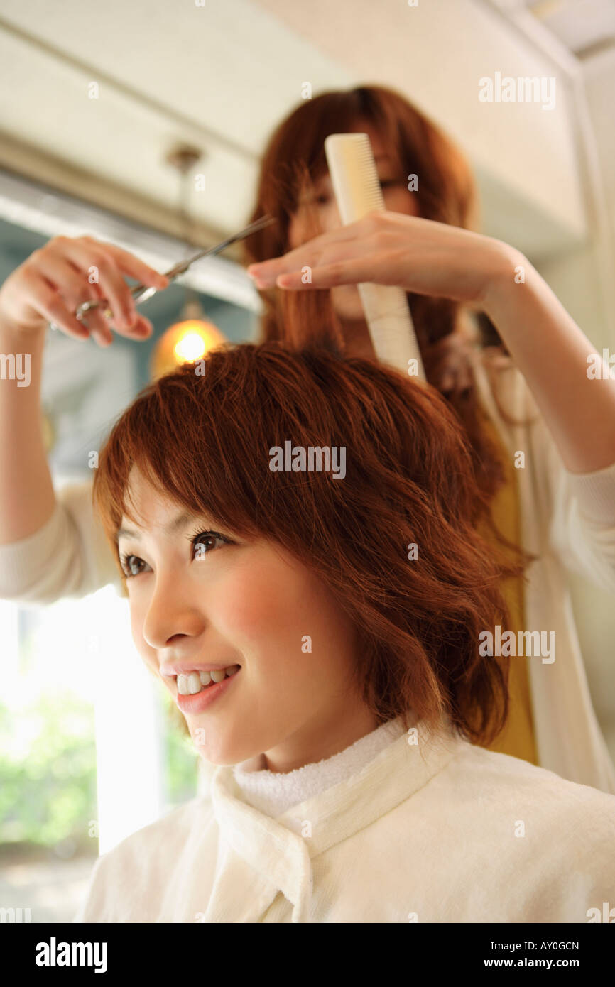 Young woman having hair cut Stock Photo - Alamy