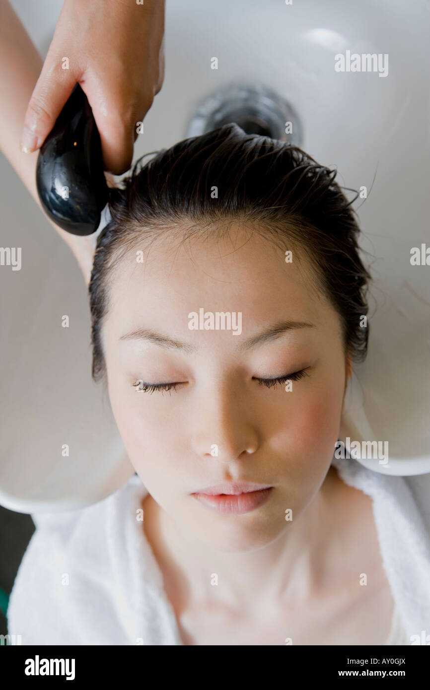 Young woman having hair washed Stock Photo - Alamy