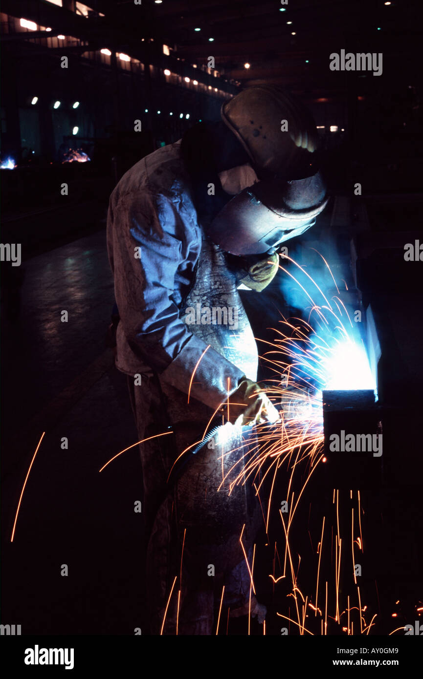 Welder at work at a sea container building factory in shanghai china ...