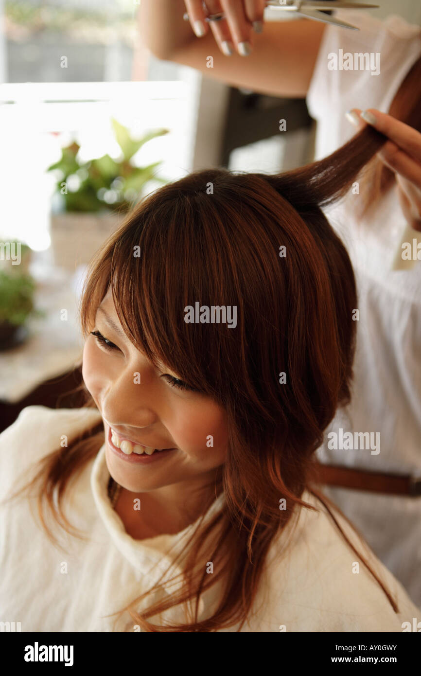 Young woman having hair cut Stock Photo - Alamy