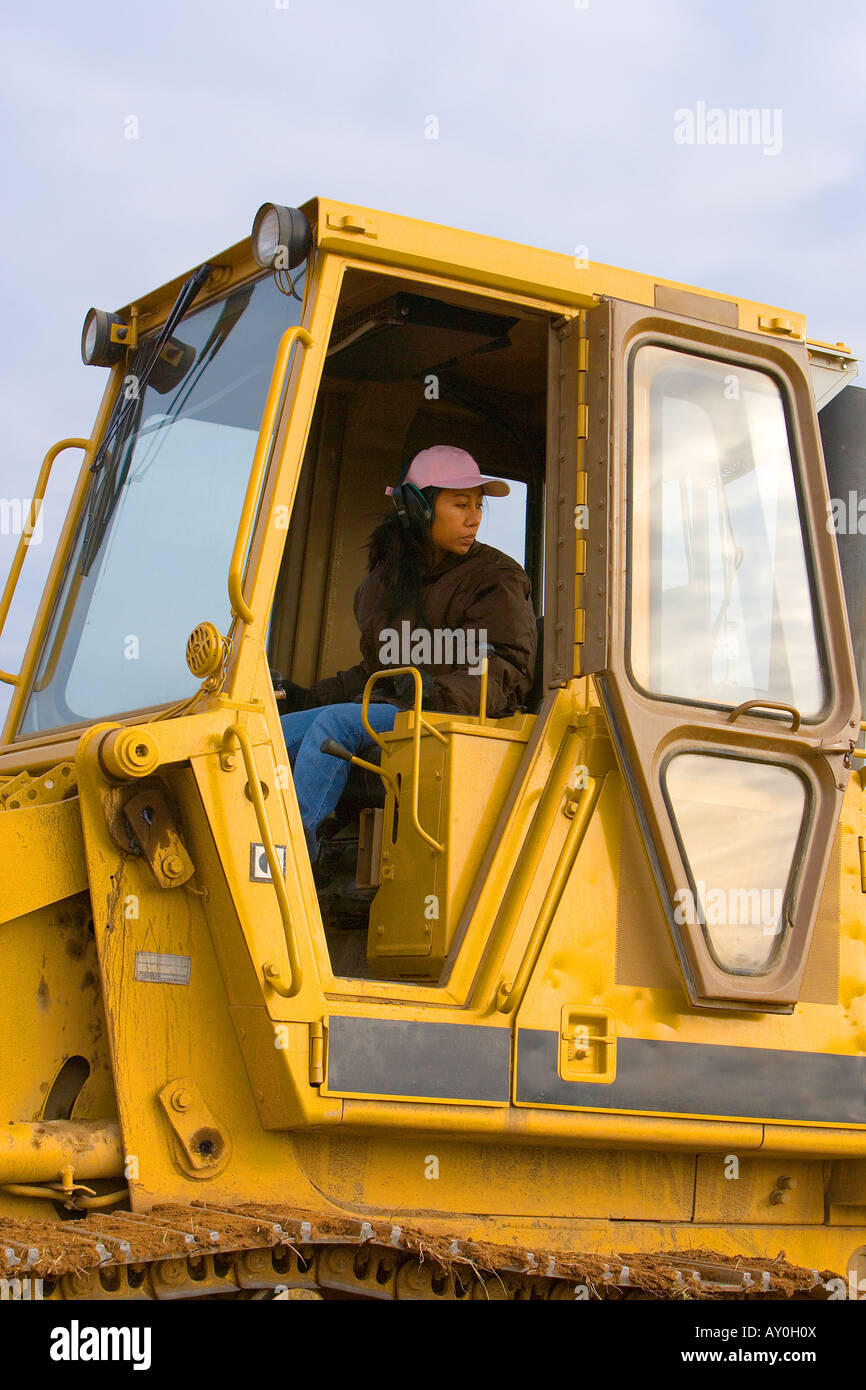 Asian woman working as bulldozer operator Stock Photo - Alamy