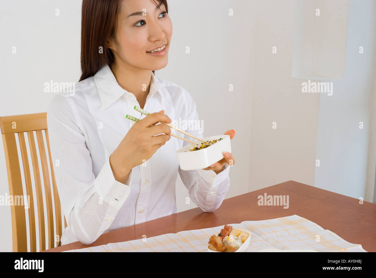 Young woman eating lunch Stock Photo - Alamy