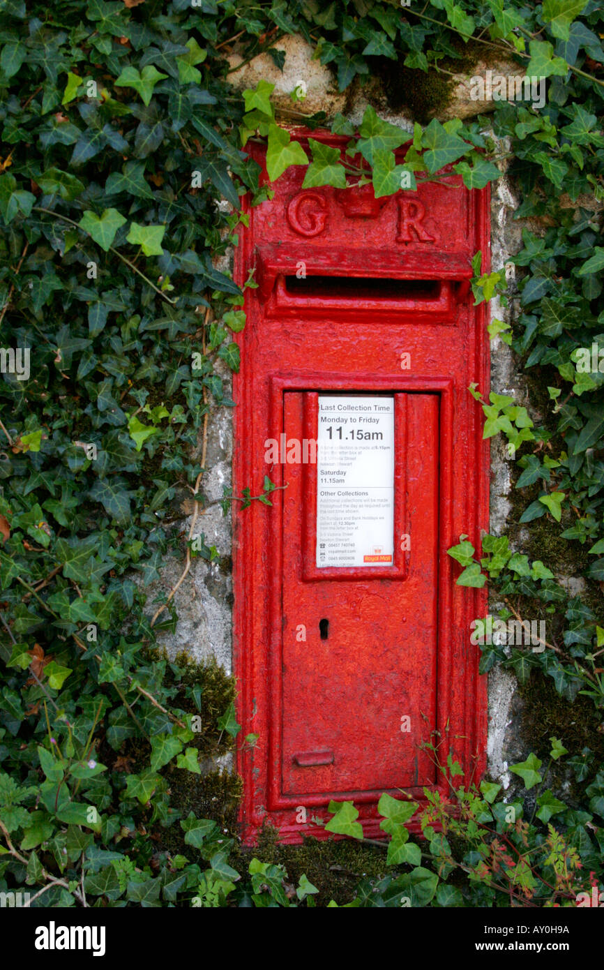 Red British George V postbox on wall surrounded with ivy Stock Photo ...
