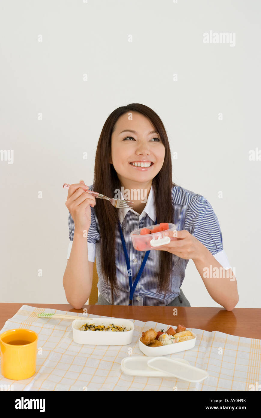 Young woman eating lunch Stock Photo - Alamy