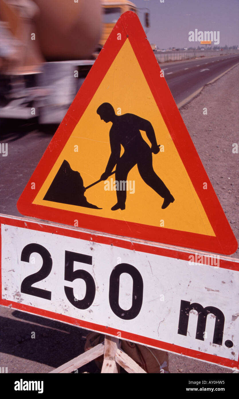 Middle east roadway sign by side of the road warning of roadworks ahead ...