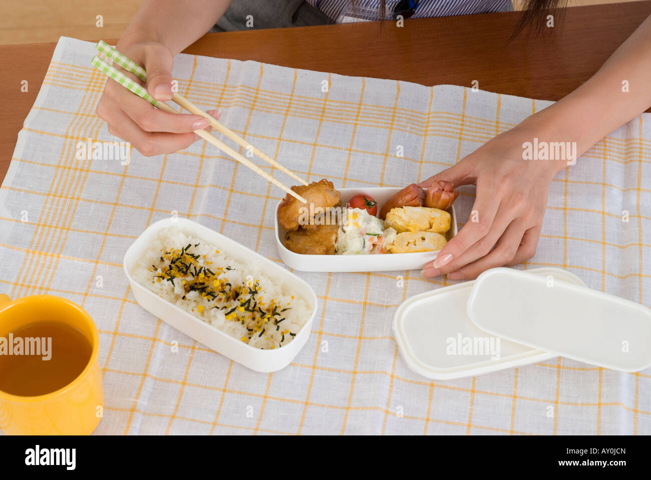 Young woman eating lunch Stock Photo - Alamy