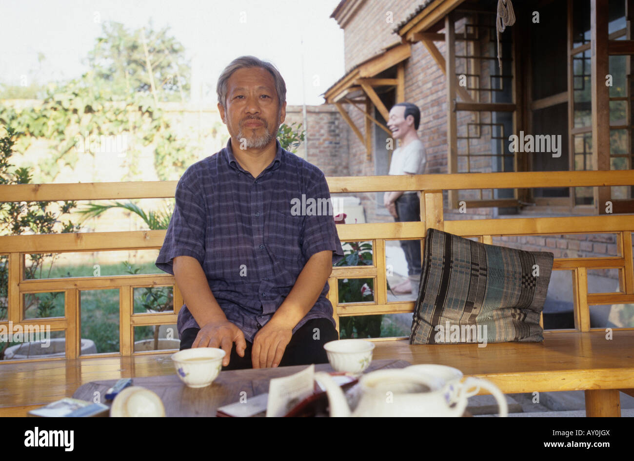 China's contemporary art critic Li Xianting poses at his home in ...